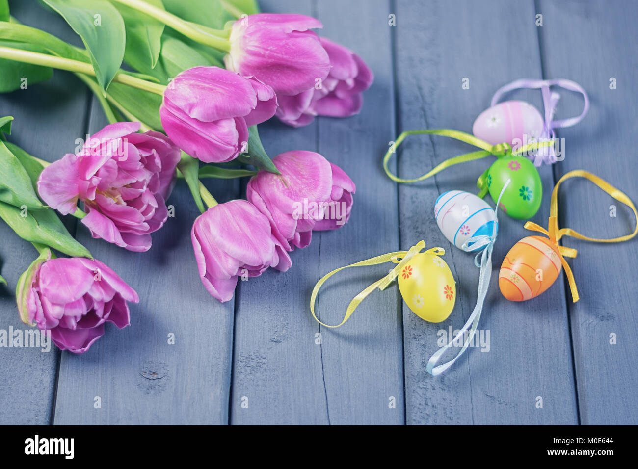 Easter composition of pink roses and colored Easter eggs Stock Photo ...
