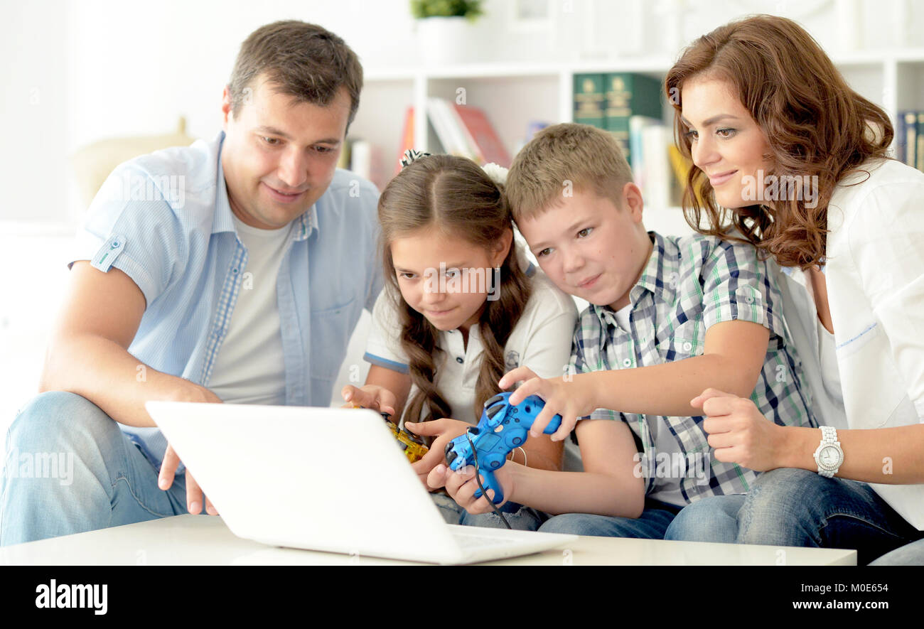 family have fun together using laptop with playstation Stock Photo - Alamy