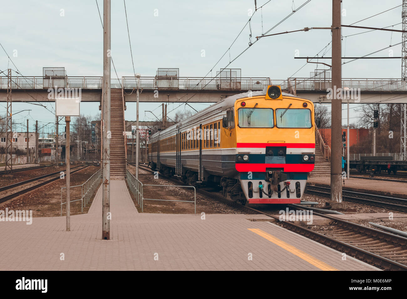 Old yellow passenger diesel train moving at the terminal Stock Photo ...