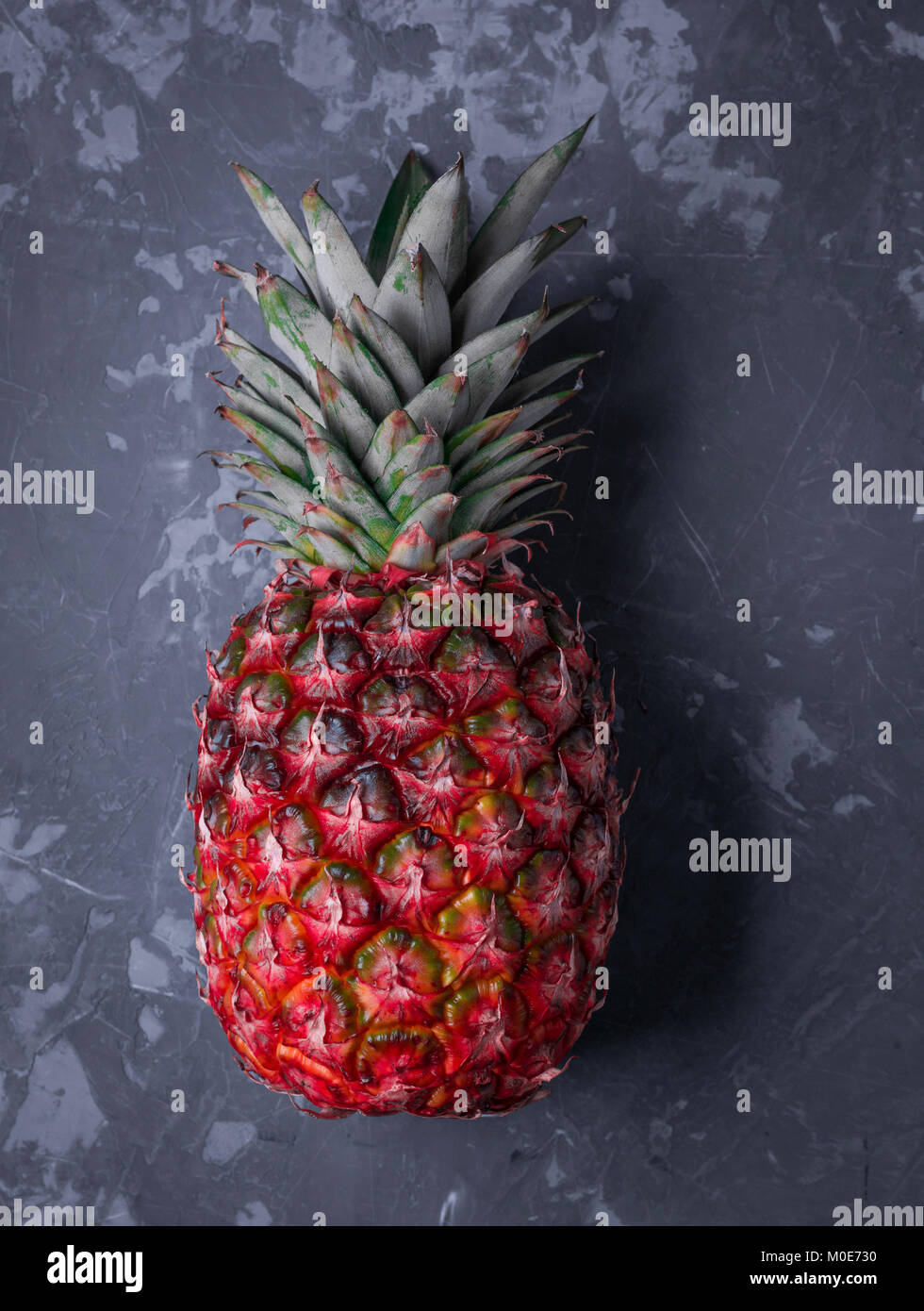Red pineapple on concrete background. Minimal style. Food concept Stock ...