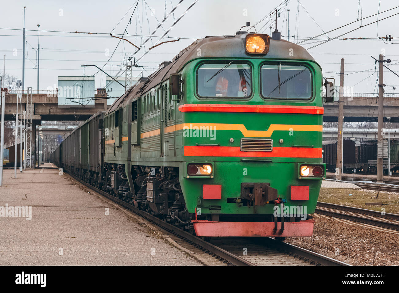 Green diesel cargo locomotive. Freight train in action Stock Photo - Alamy
