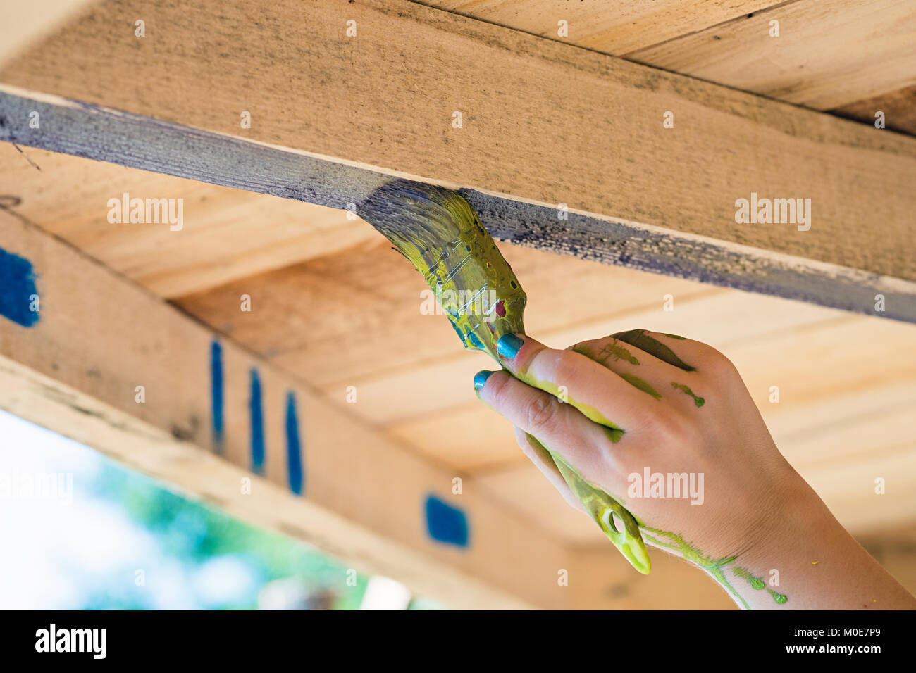 Female hand painting colorful wooden structure with brush Stock Photo ...