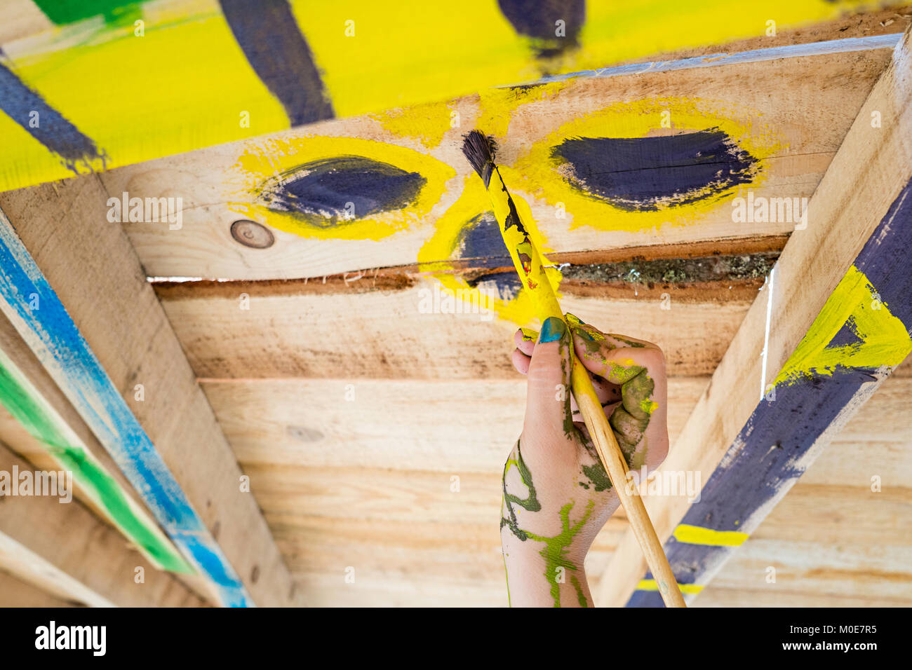 Female hand painting colorful wooden structure with brush Stock Photo ...
