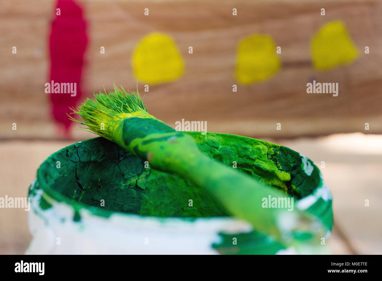 Green paintbrush in a can with green paint Stock Photo - Alamy