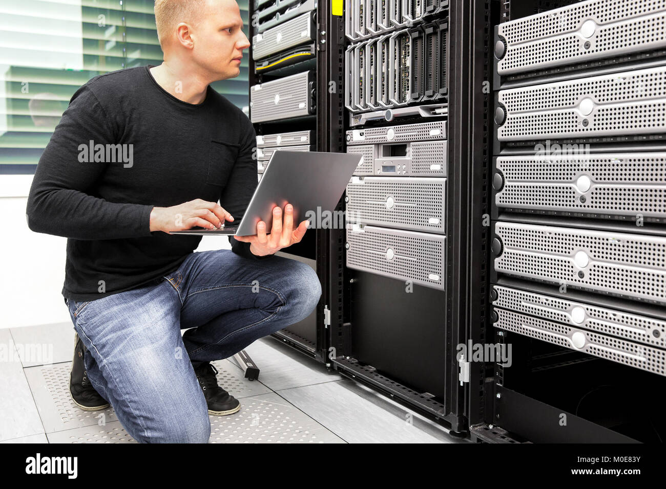 Consultant With Laptop Monitoring Servers In Datacenter Stock Photo - Alamy