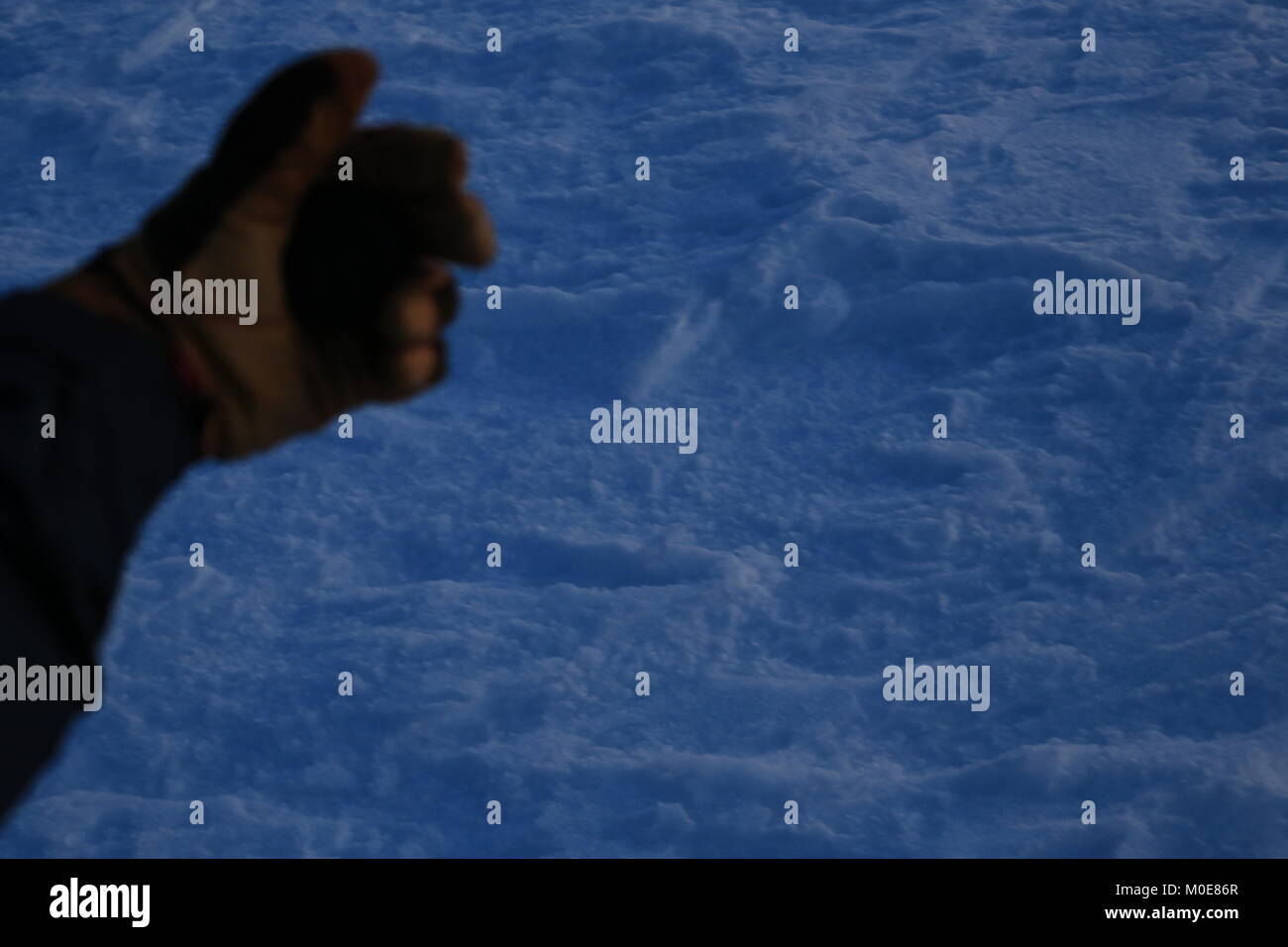 Skiers Hand In Glove, Snow background Stock Photo - Alamy