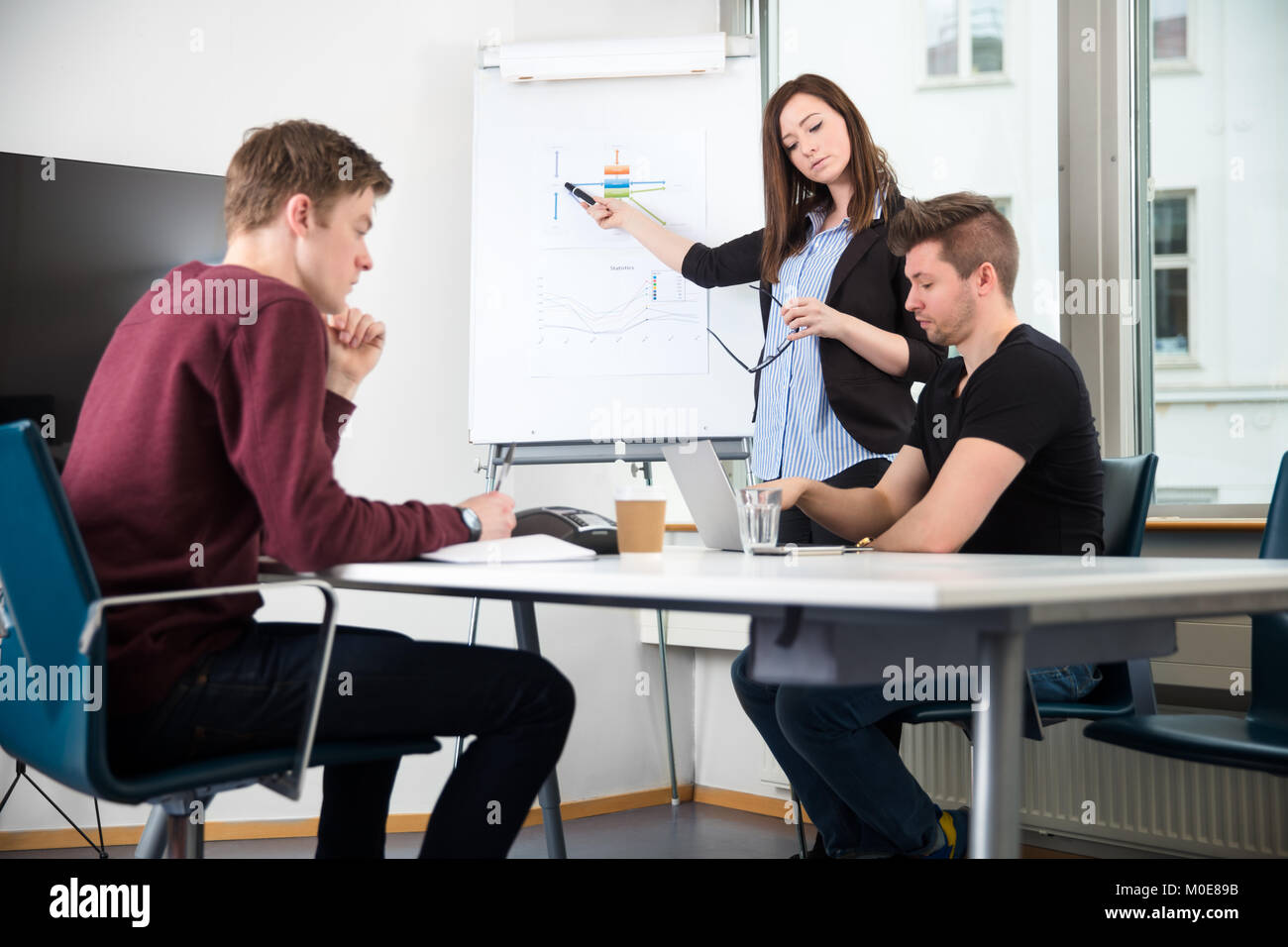 Businesswoman Giving Presentation While Using Laptop With Collea Stock ...