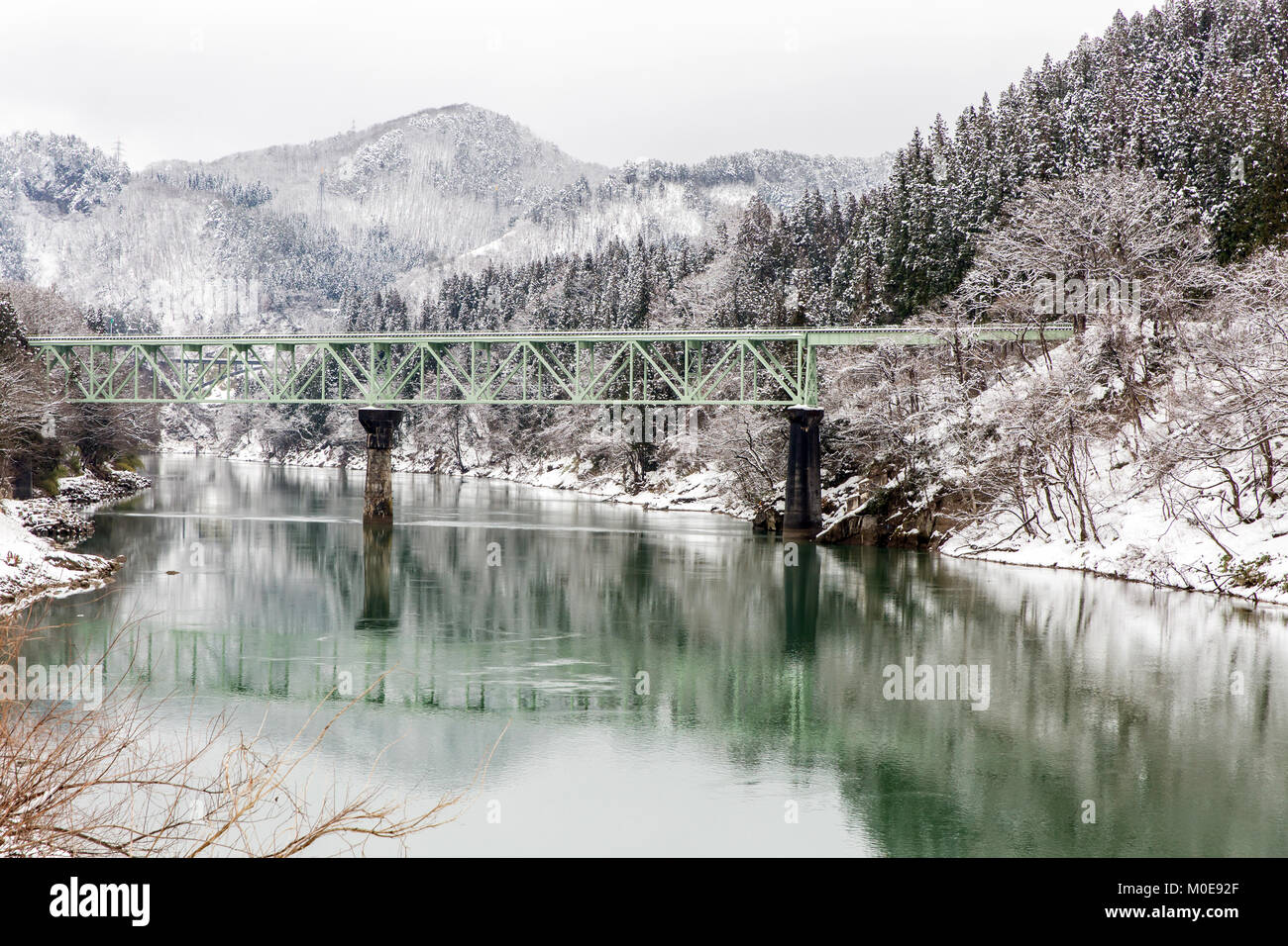 Train in Winter landscape snow on bridge Stock Photo - Alamy