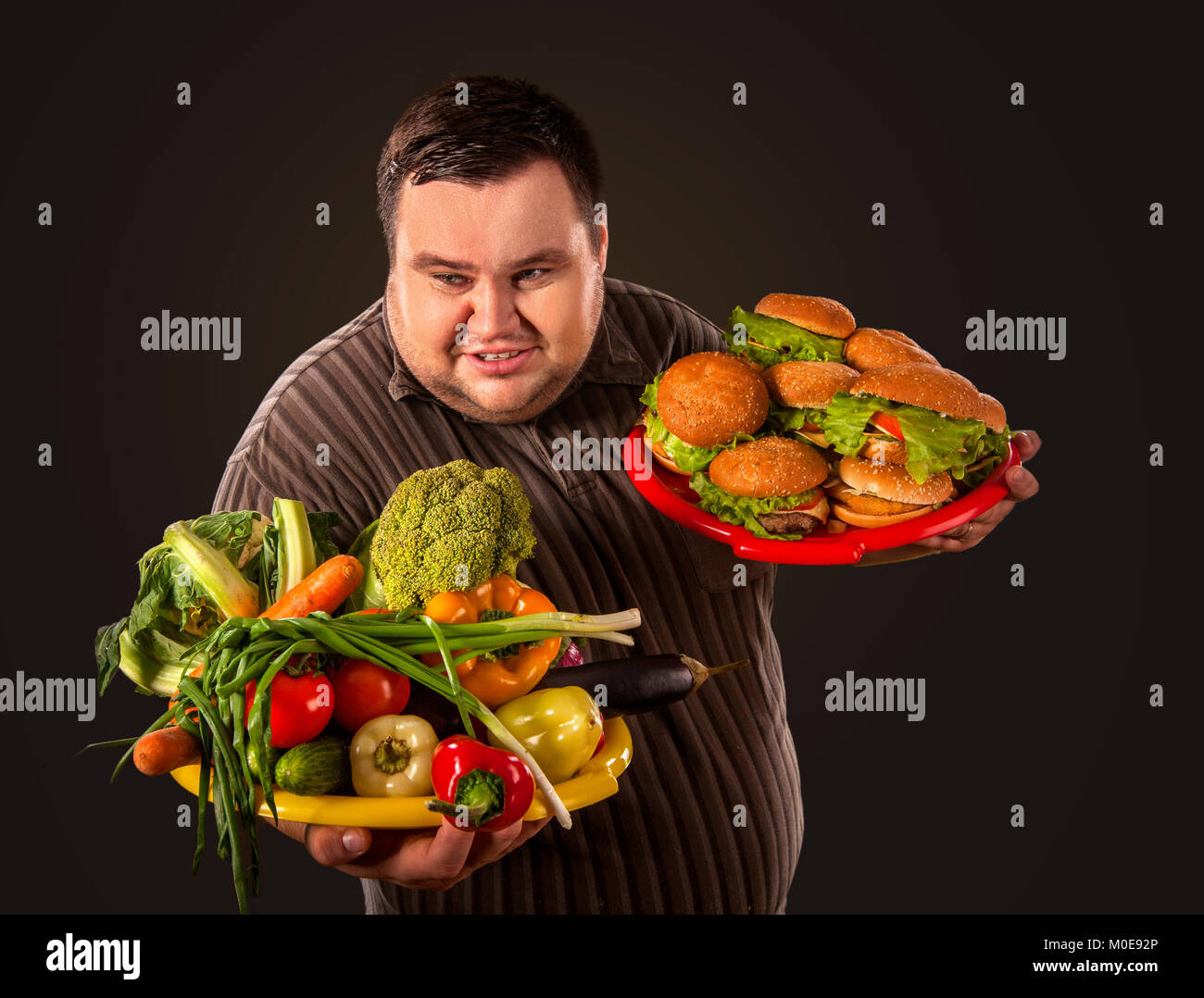 Diet fat man makes choice between healthy and unhealthy food Stock ...