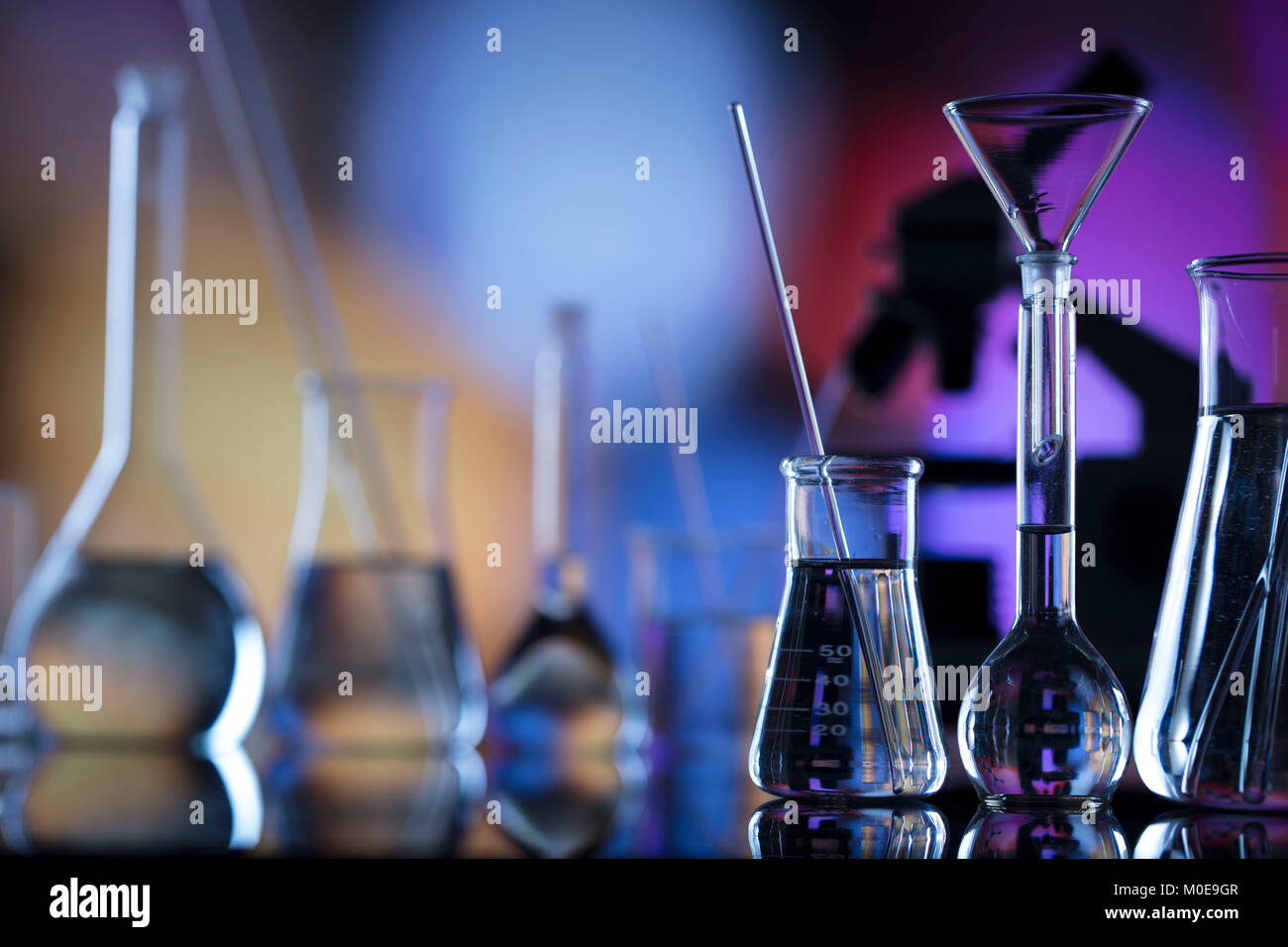 Science concept background. Microscope and laboratory glassware ...