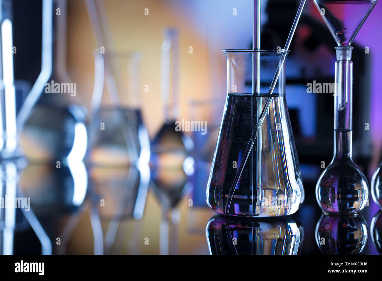 Science concept background. Microscope and laboratory glassware ...