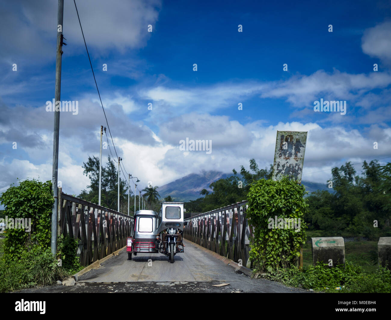 Daraga, Albay, Philippines. 21st Jan, 2018. A tricycle taxi crosses a ...