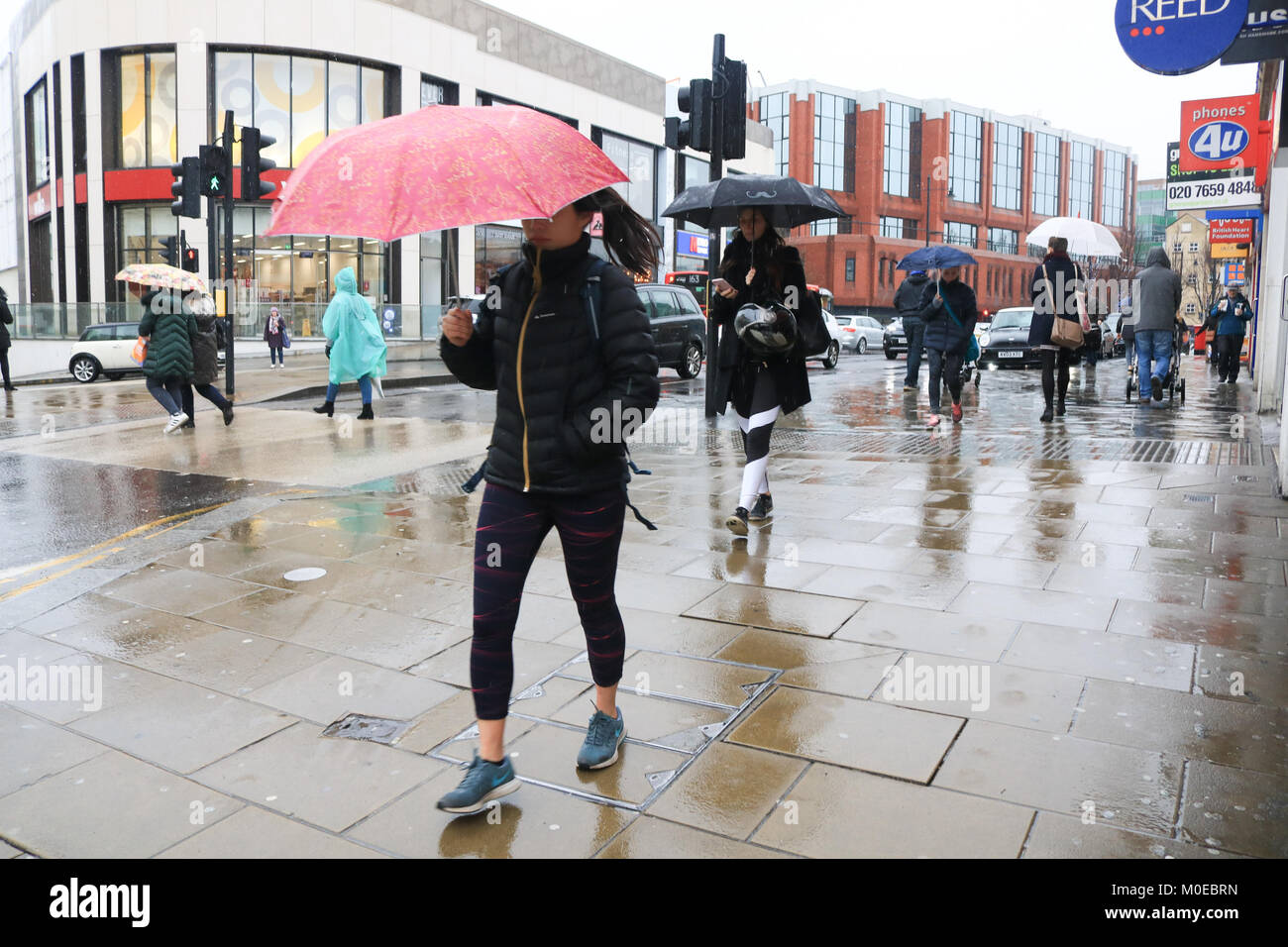 London UK. 21st January 2018. Pedestrians are caught in freezing rain ...