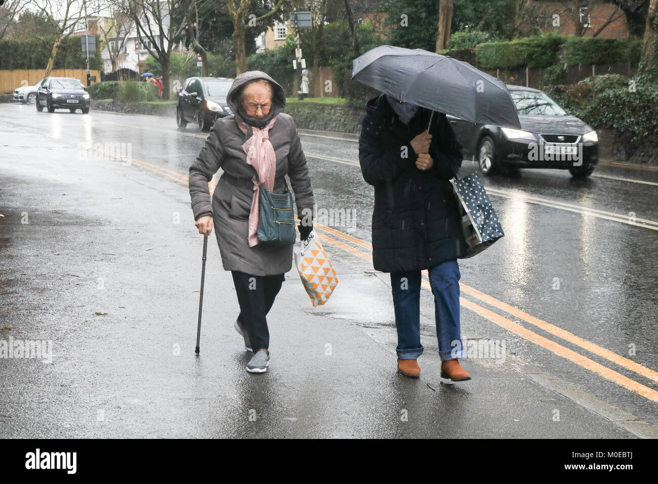 London UK. 21st January 2018. Pedestrians are caught in freezing rain ...