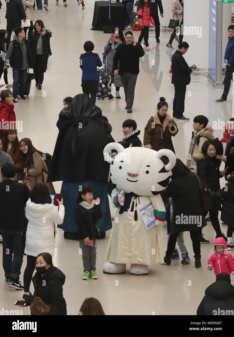 22nd Jan, 2018. Olympic mascots at airport Tourists pose with the ...