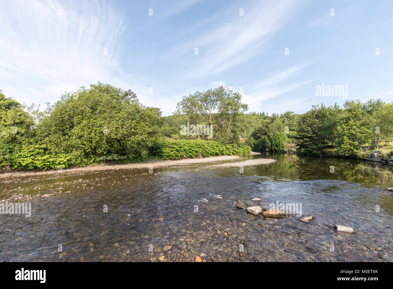 A calm and shallow section of the fishing river at Llanidloes, Powys ...