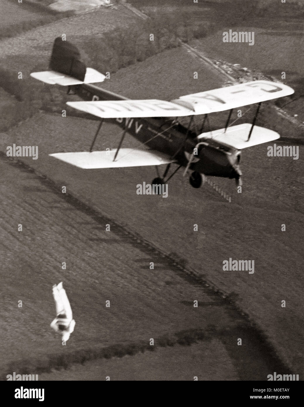 Parachuctisit jumps headfirst from biplane, Hayes, 1933 Stock Photo - Alamy