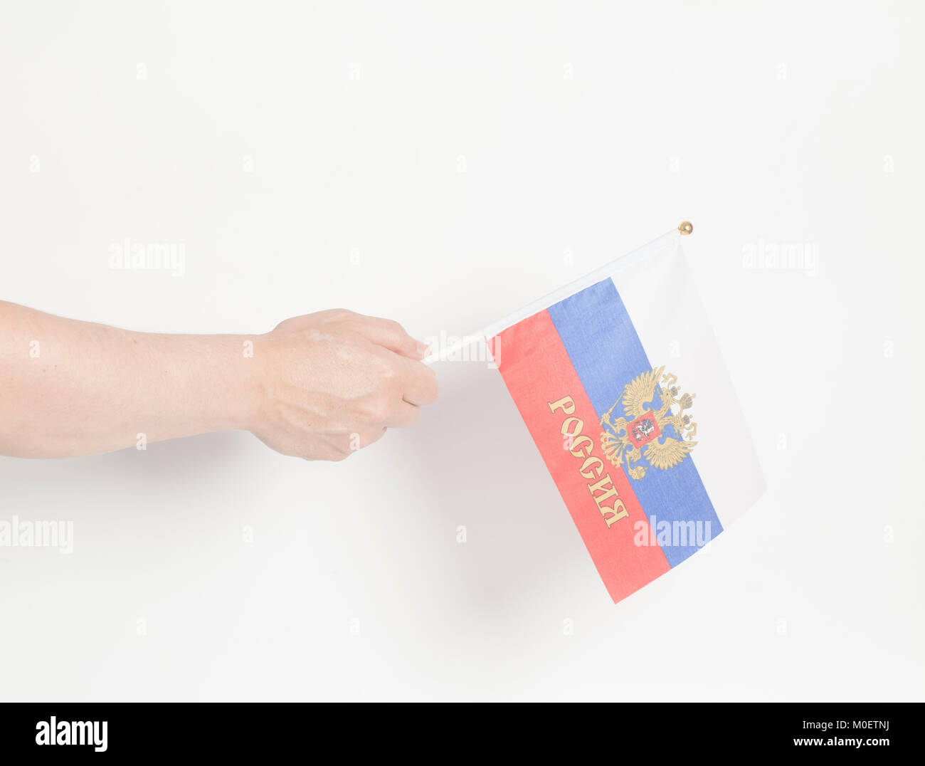Human hand holding Russian flag with emblem of Russia on white Stock ...