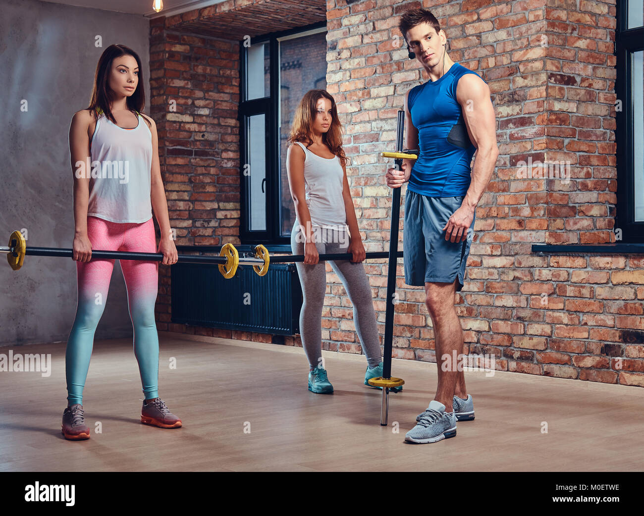 A man shows how to do back workouts Stock Photo - Alamy