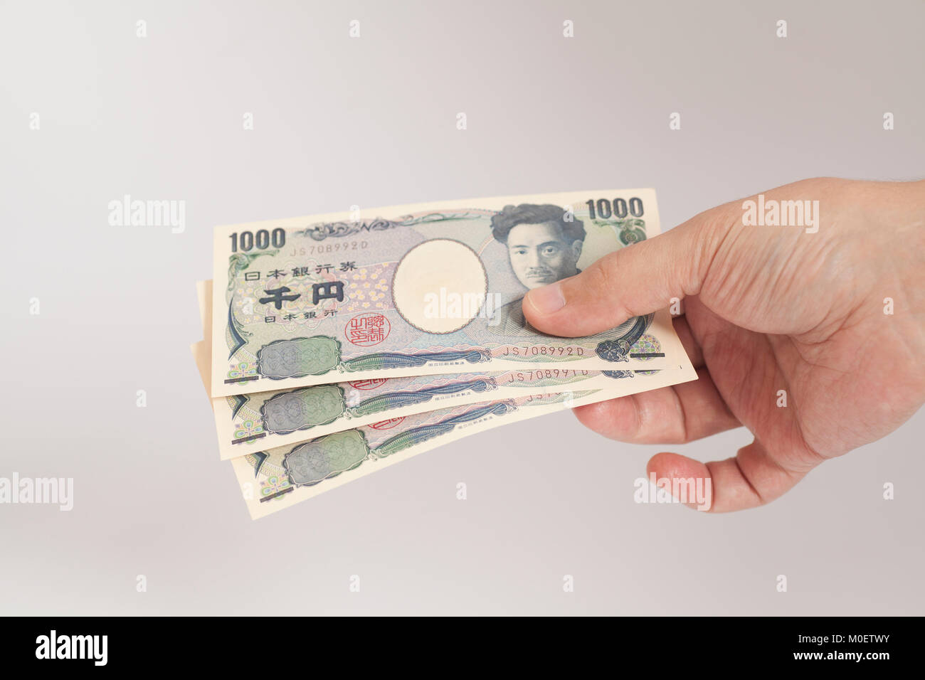 Japanese money one thousand yen in man hand on white background Stock ...