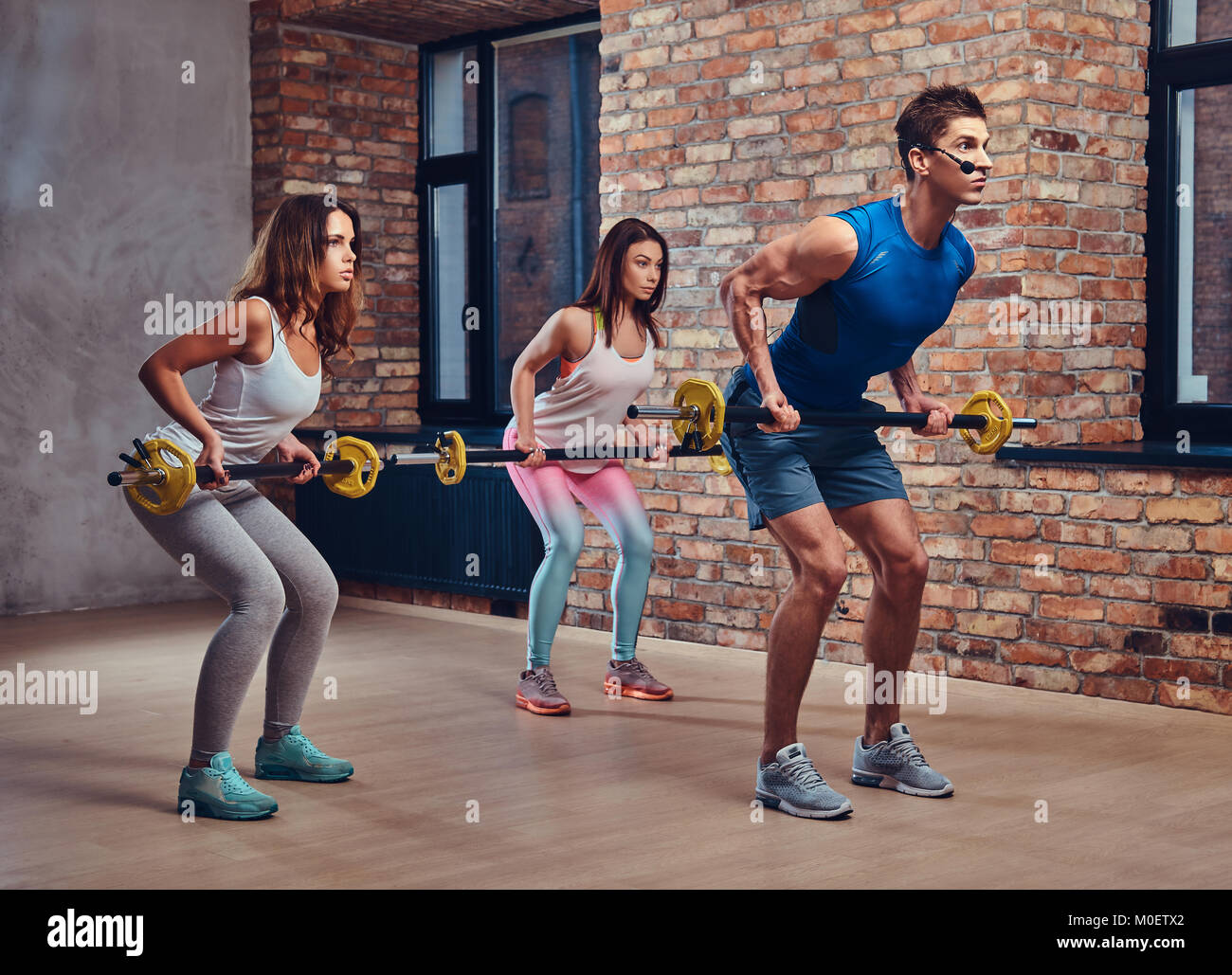 A man shows how to do back workouts Stock Photo - Alamy