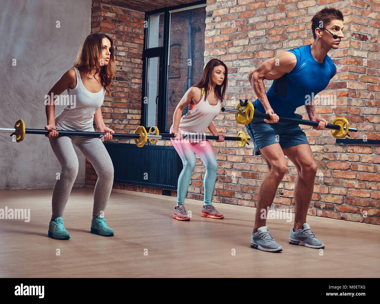 A man shows how to do back workouts Stock Photo - Alamy