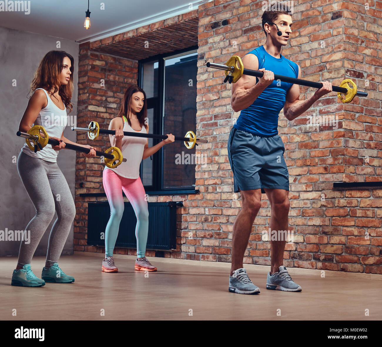 A man shows how to do back workouts Stock Photo - Alamy