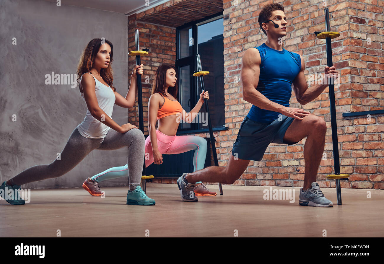 Adults doing squats Stock Photo - Alamy