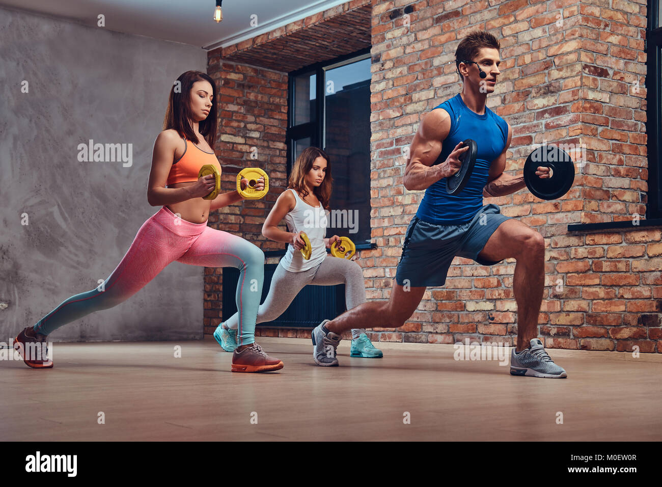 Adults doing squats Stock Photo - Alamy
