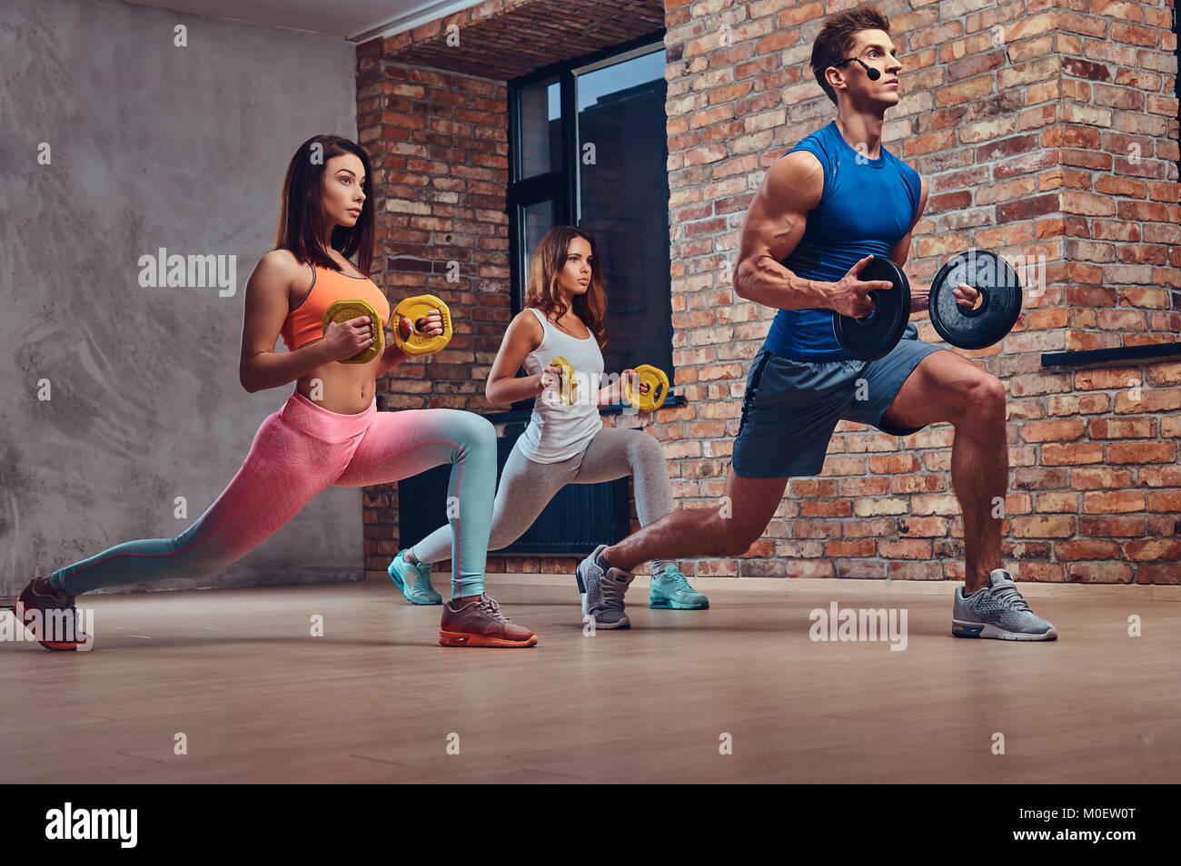 Adults doing squats Stock Photo - Alamy