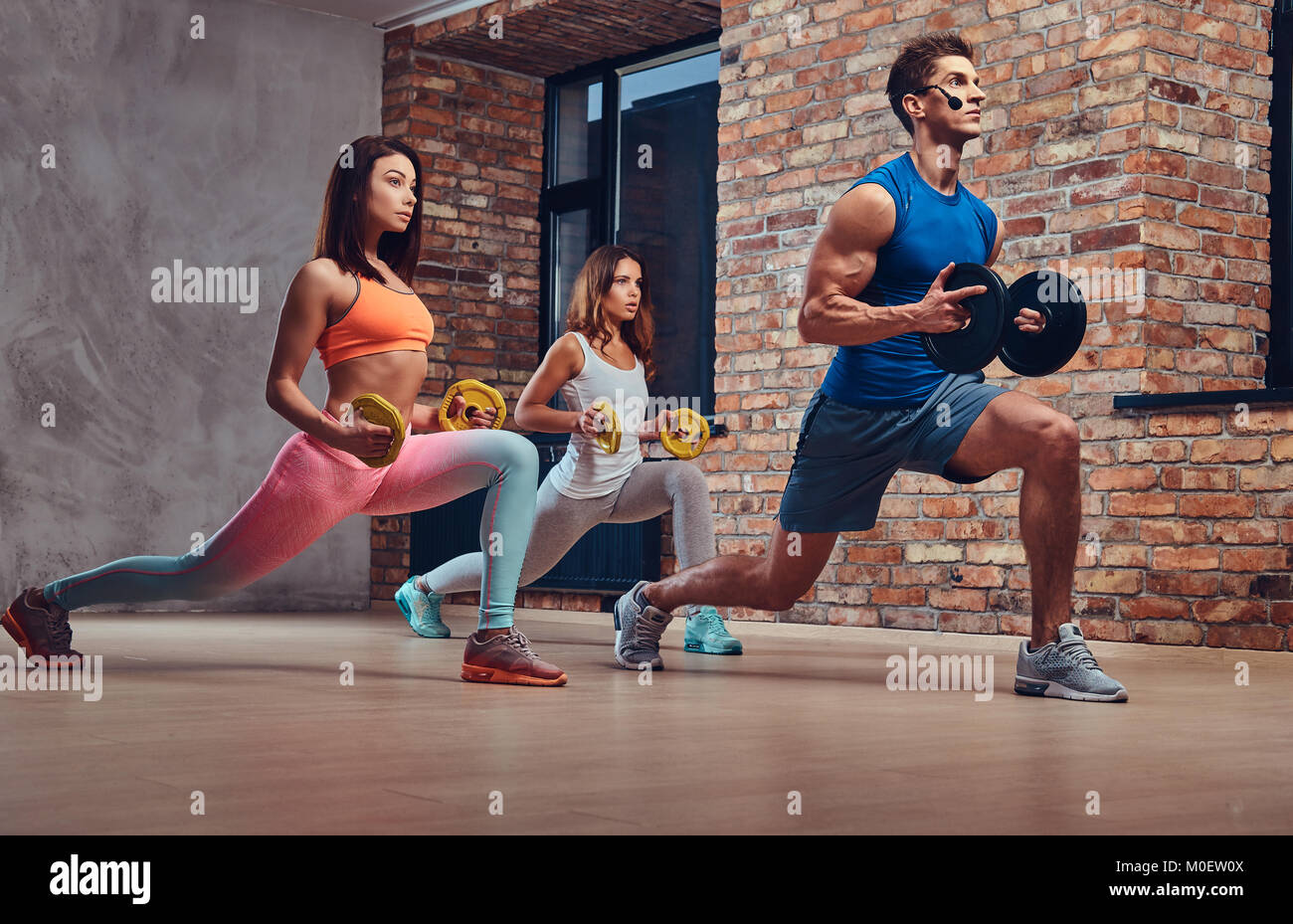 Adults doing squats Stock Photo - Alamy