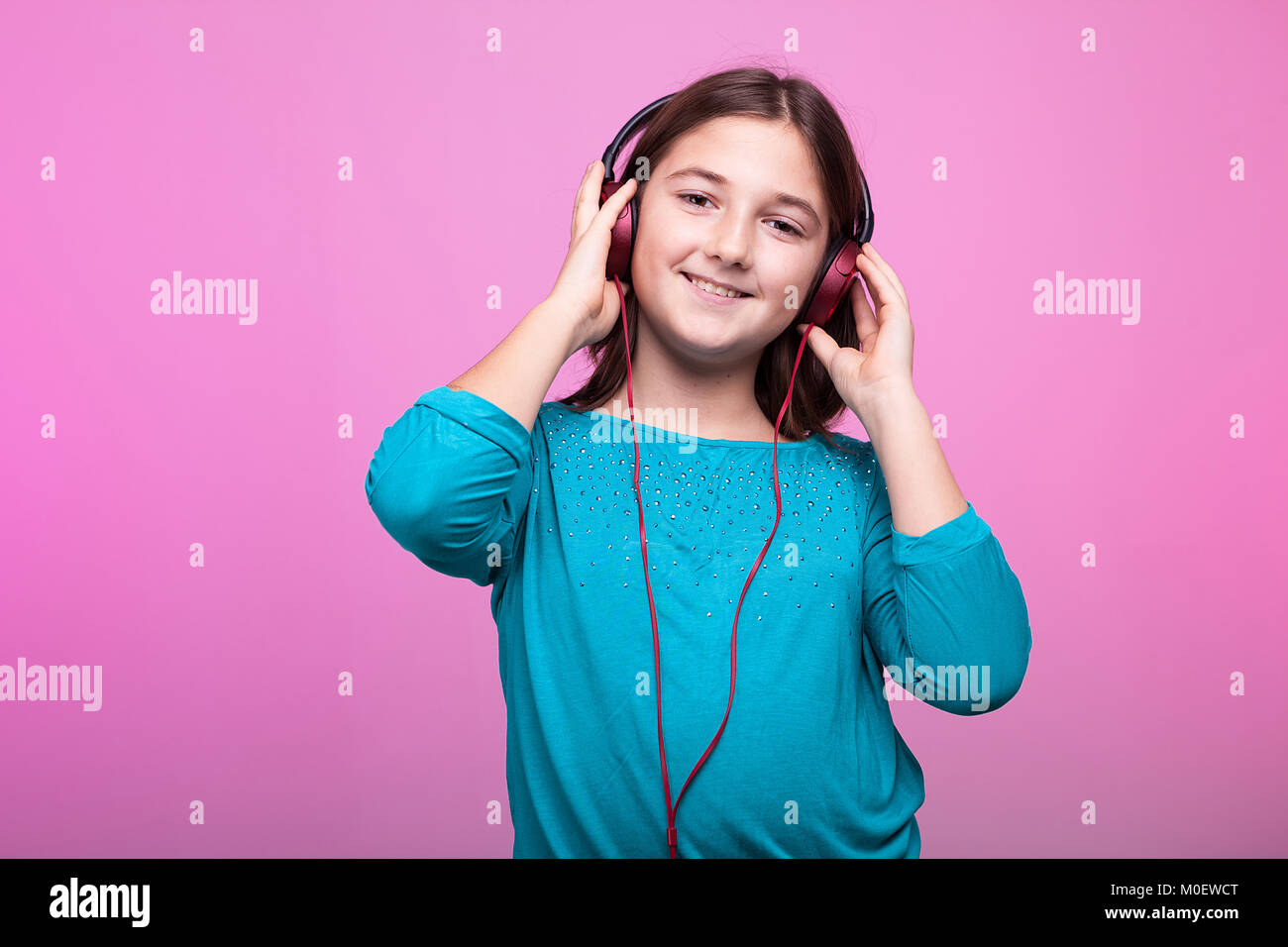Happy kid with his headset listening to music Stock Photo - Alamy