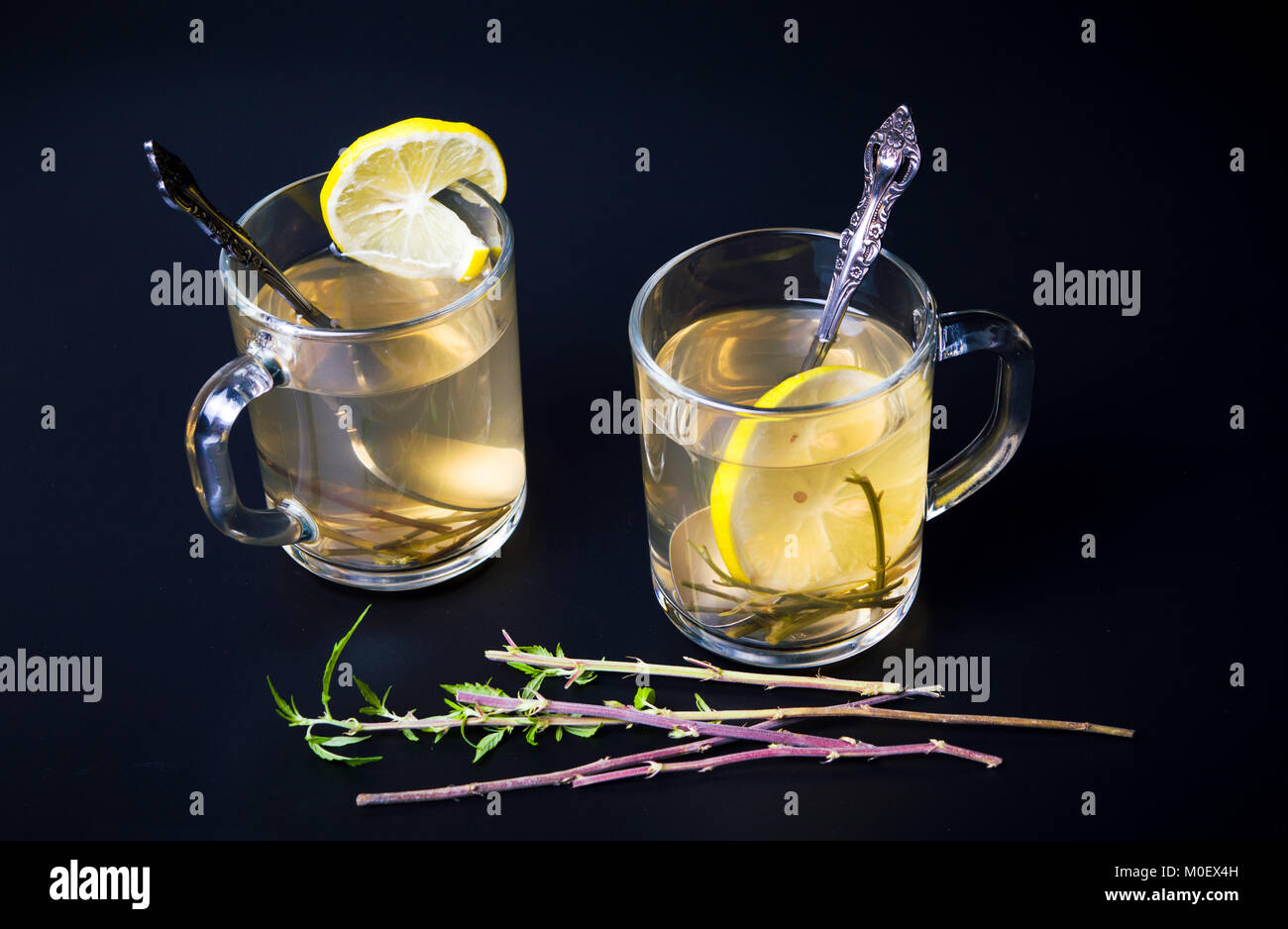 Cannabis tea with marijuana branch and lemon Stock Photo - Alamy