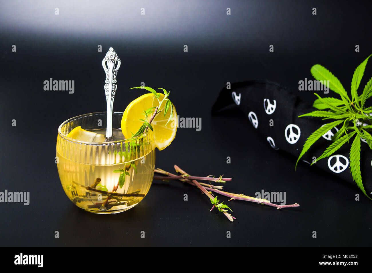 Cannabis tea with marijuana branch and lemon Stock Photo - Alamy
