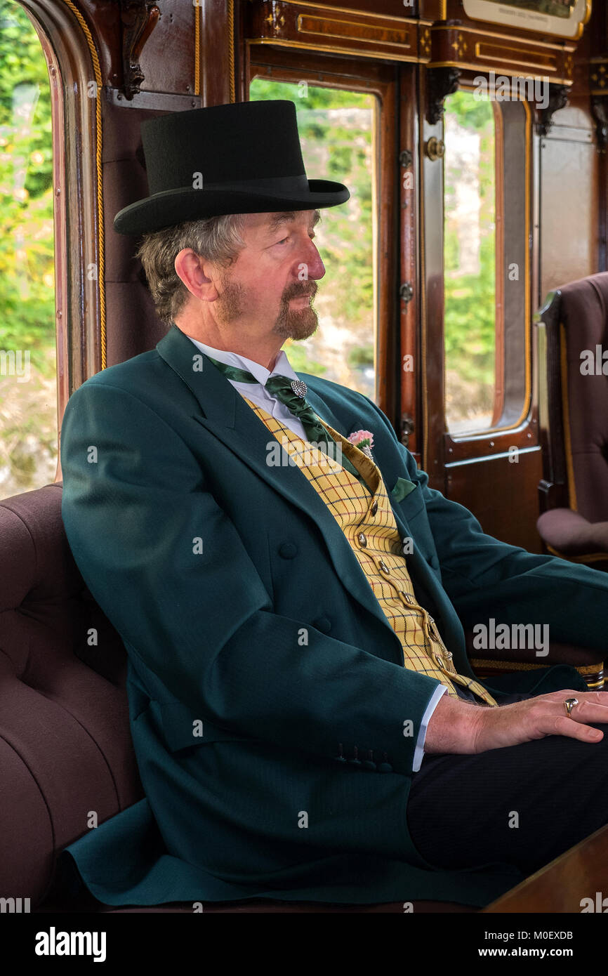 man sitting in a railway carriage dressed in victorian clothing for the ...