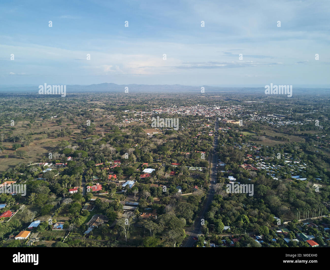 Aerial view of Diriamba city on sunny day light. Small city in valley ...
