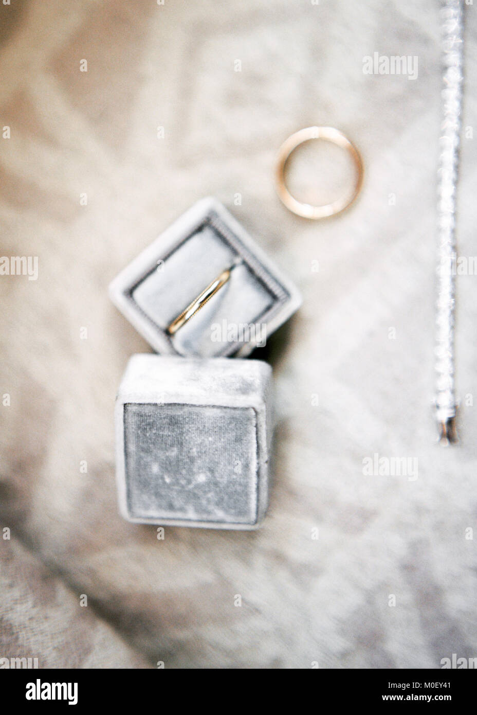 Two wedding rings and a bracelet Stock Photo - Alamy