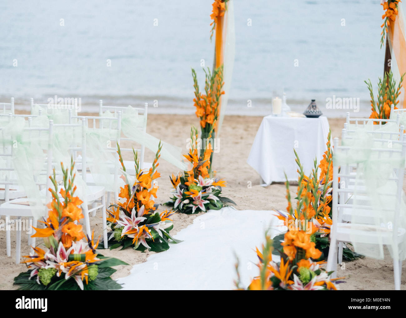 Floral arrangements at a wedding on the beach Stock Photo - Alamy