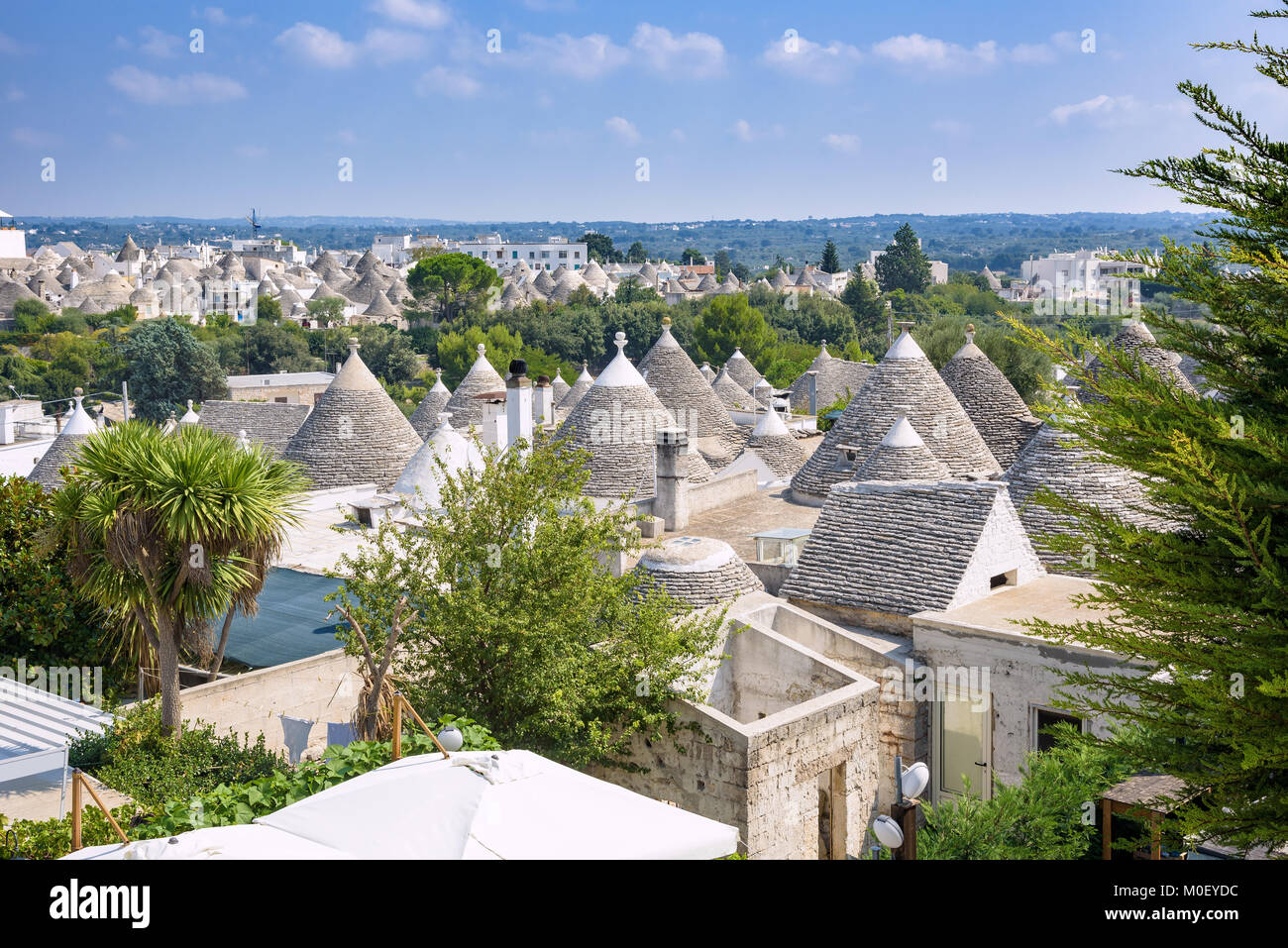 Panoramic view of famous Alberobello town with trulli houses and their ...