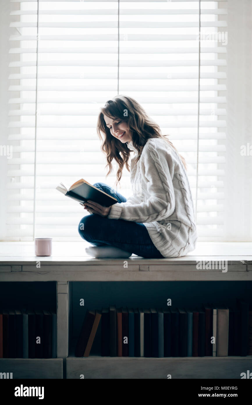 Cozy reading book window hi-res stock photography and images - Alamy