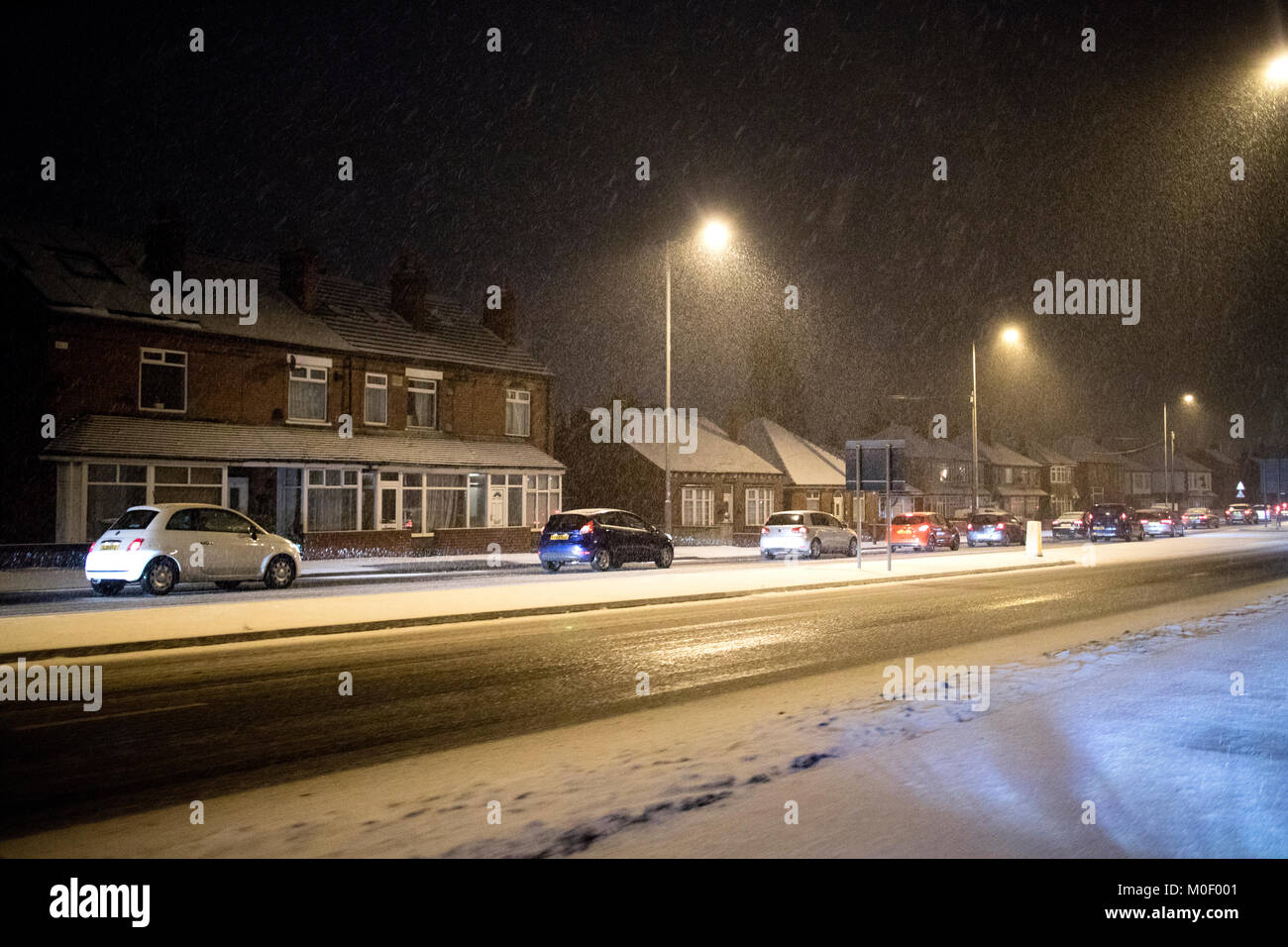 Traffic driving in snowy winter conditions at night Stock Photo - Alamy