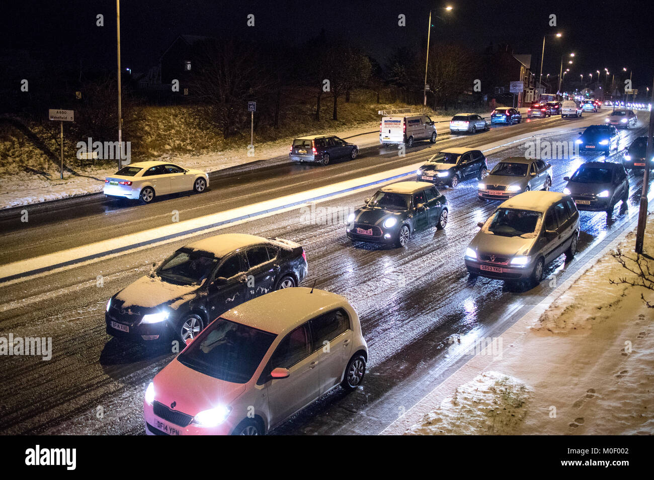 Traffic driving in snowy winter conditions at night Stock Photo - Alamy