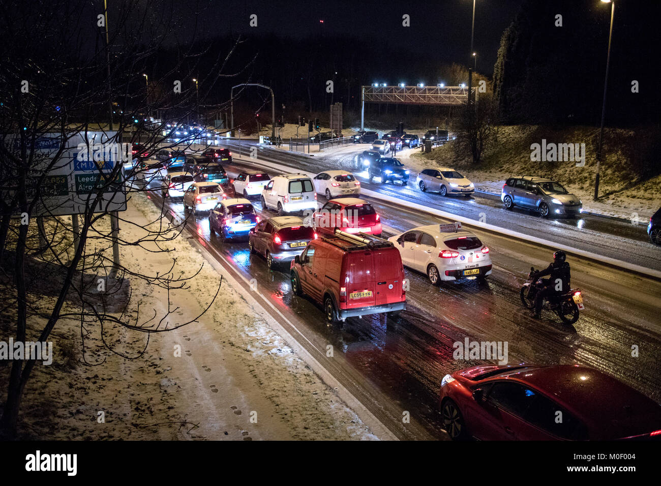 Traffic driving in snowy winter conditions at night Stock Photo - Alamy