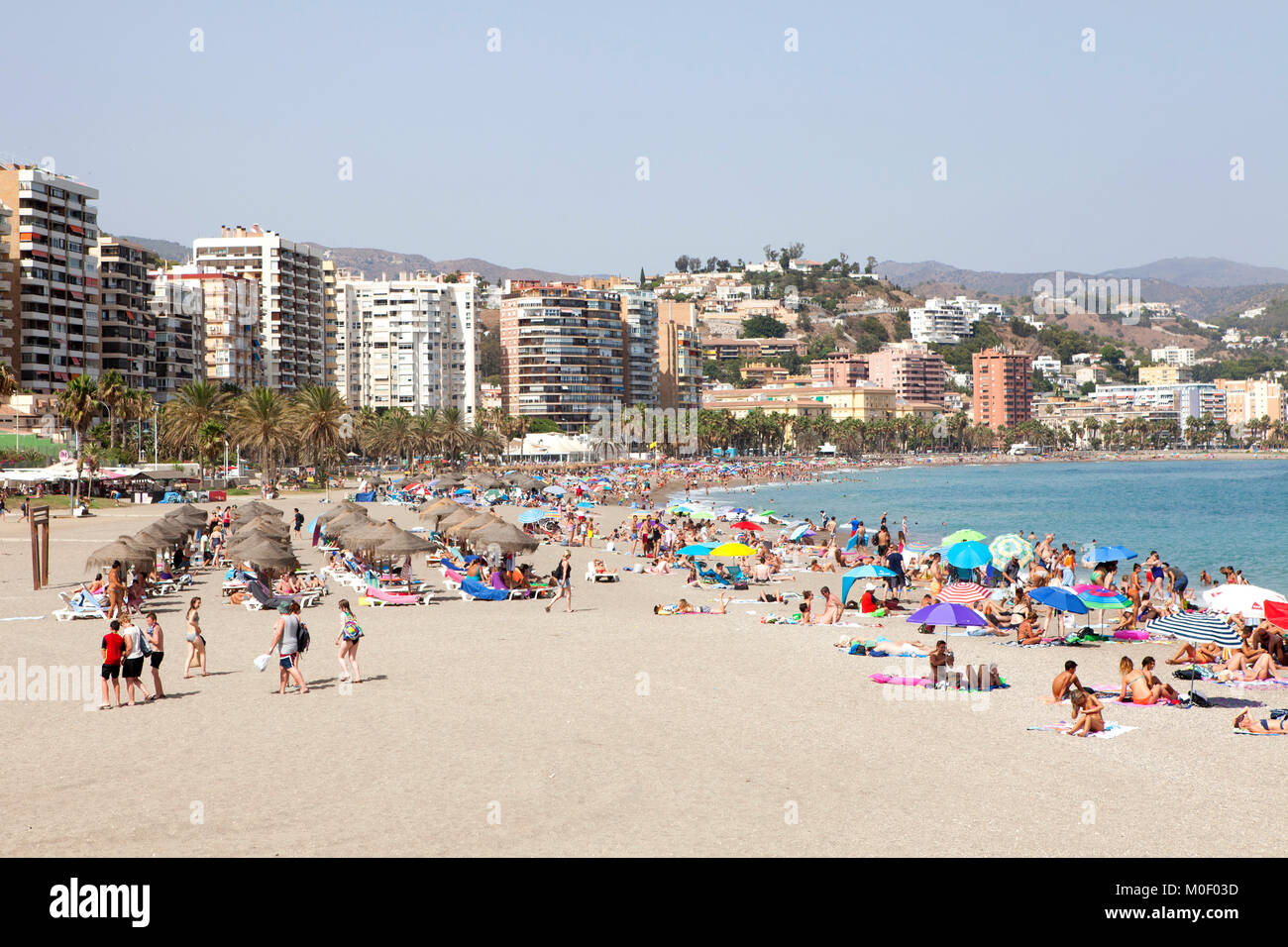 Sunbathers, tourists and locals enjoying the sun, sea and sand at Playa ...