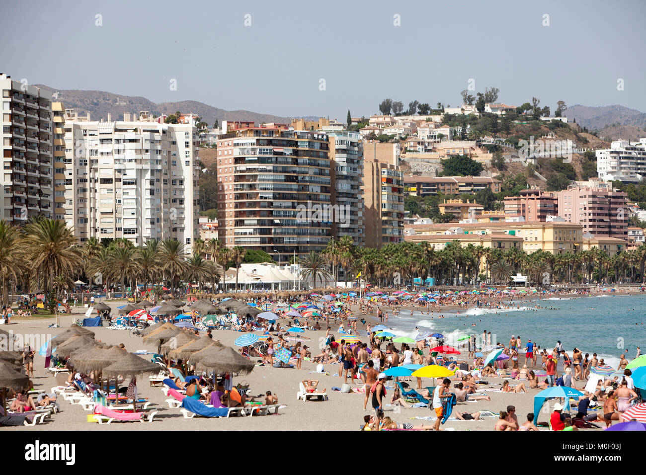 Sunbathers, tourists and locals enjoying the sun, sea and sand at Playa ...