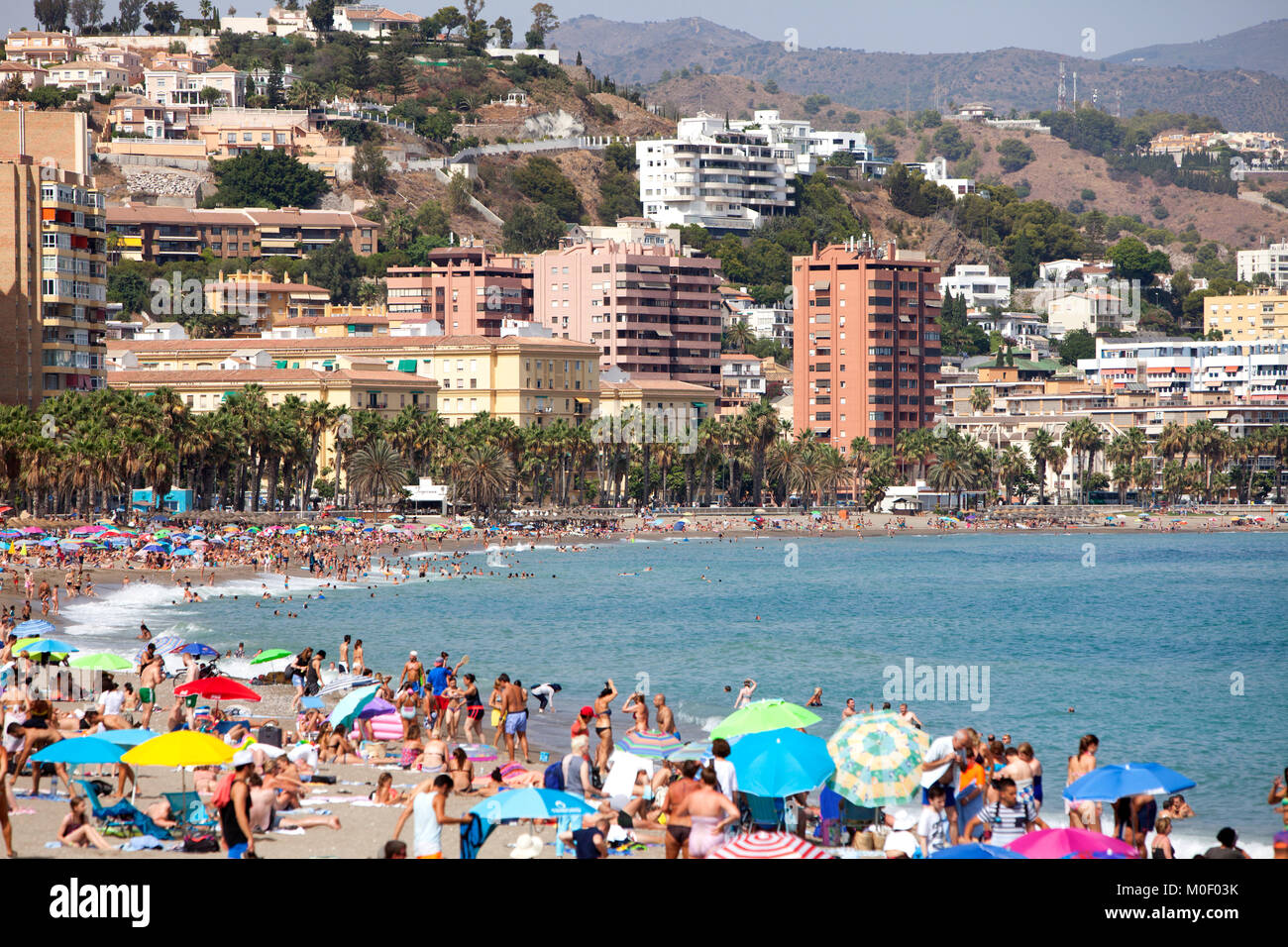 Sunbathers, tourists and locals enjoying the sun, sea and sand at Playa ...