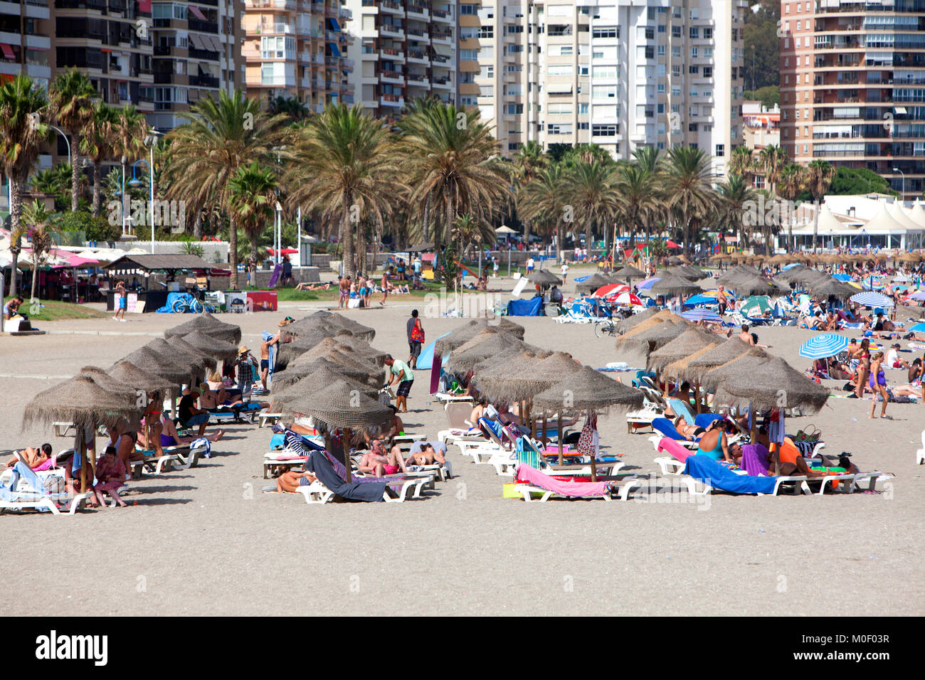 Sunbathers, tourists and locals enjoying the sun, sea and sand at Playa ...