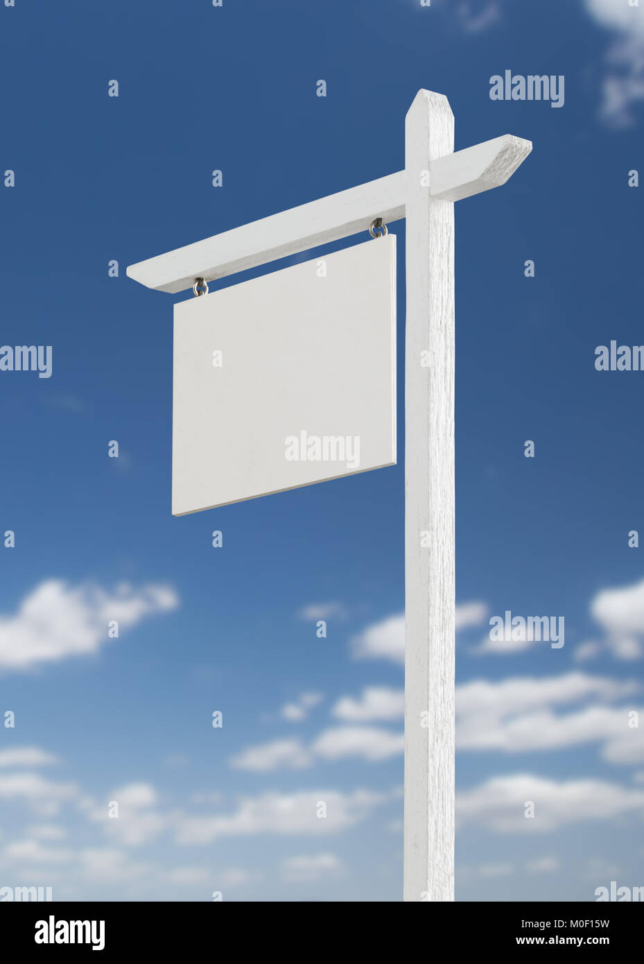 Blank Real Estate Sign Over A Blue Sky with Clouds Stock Photo - Alamy