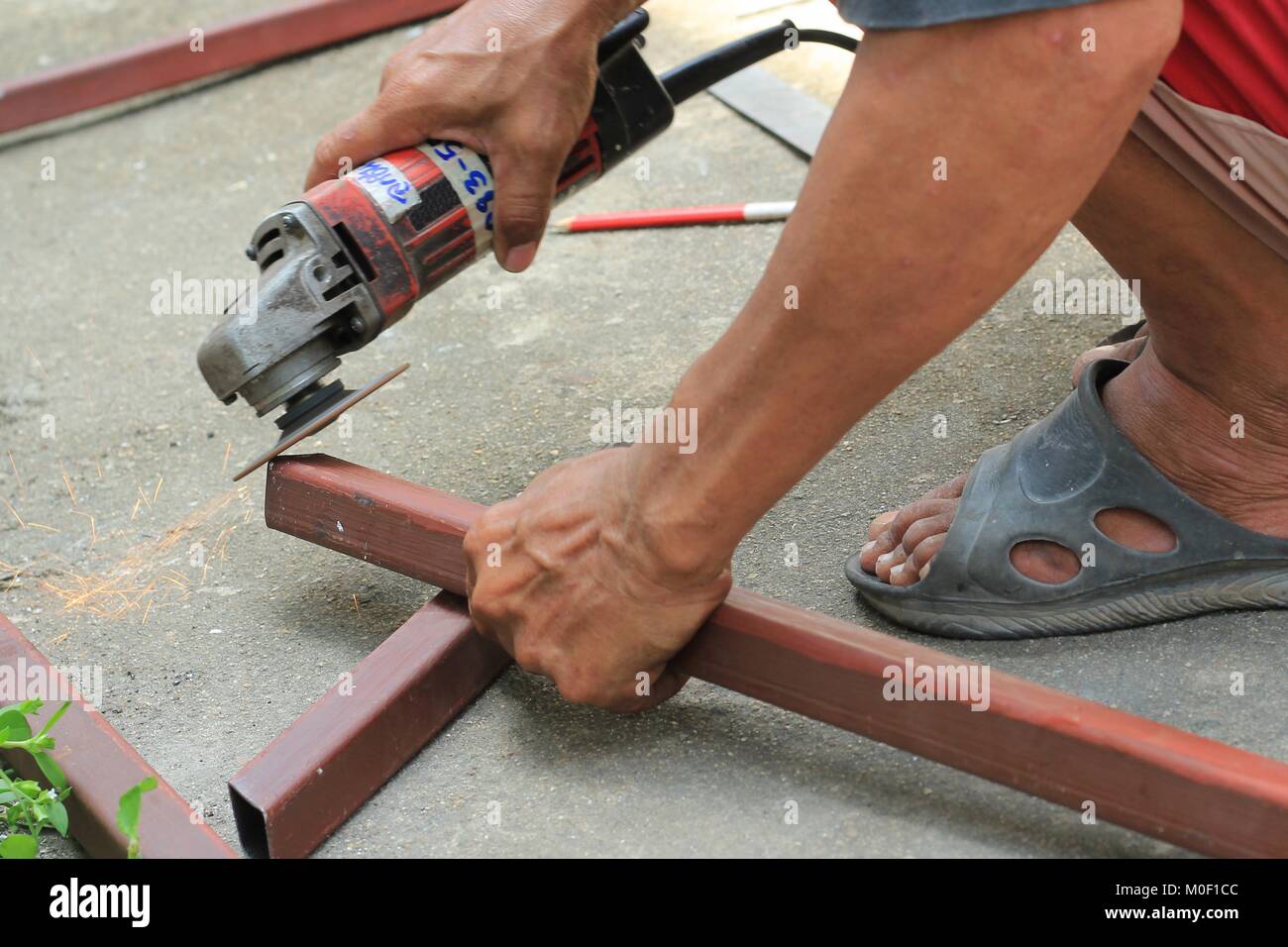 A man working with grinder, close up on tool Stock Photo - Alamy