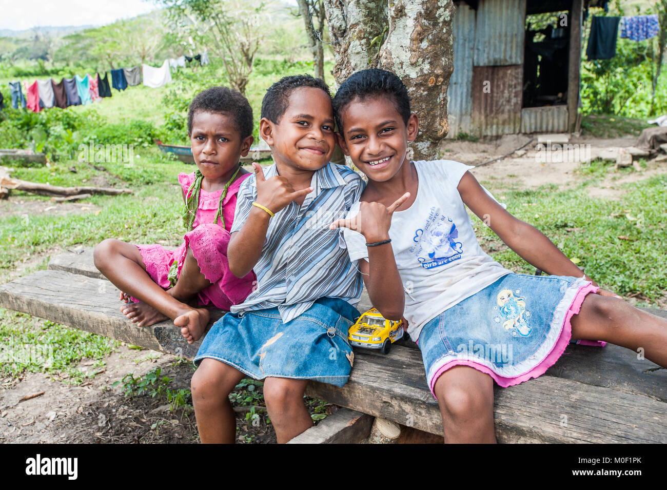 Young children pose for the camera in a remote small village in the ...